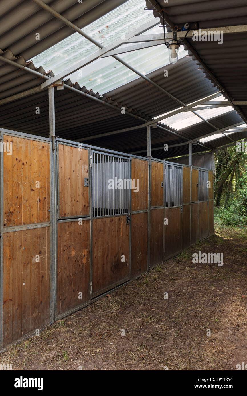 Empty boxes for horses in a rural area of Italy Stock Photo - Alamy