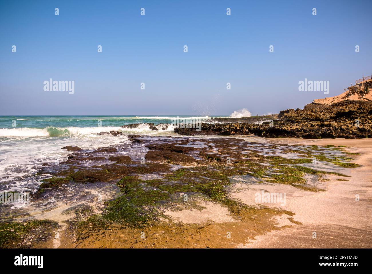Atlantic Ocean in Morocco, water splashing on the rocks on a windy day ...