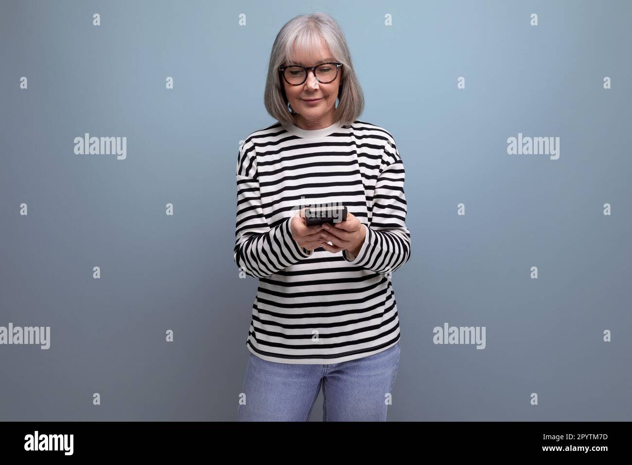 middle aged business woman surfs the internet using smartphone on ...