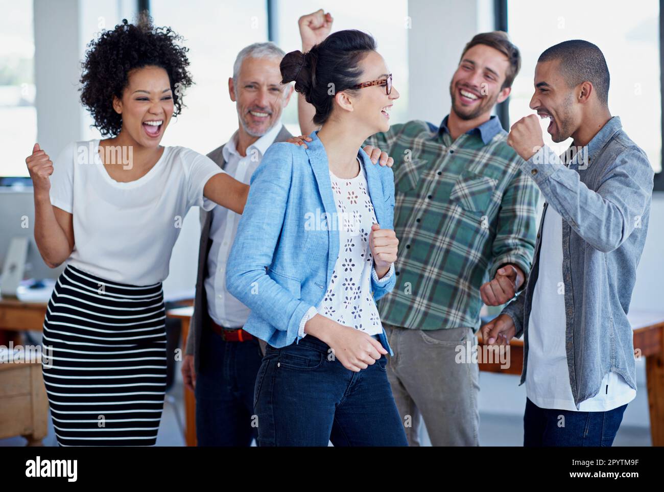 Theyre one amazing team. a group of happy coworkers celebrating ...