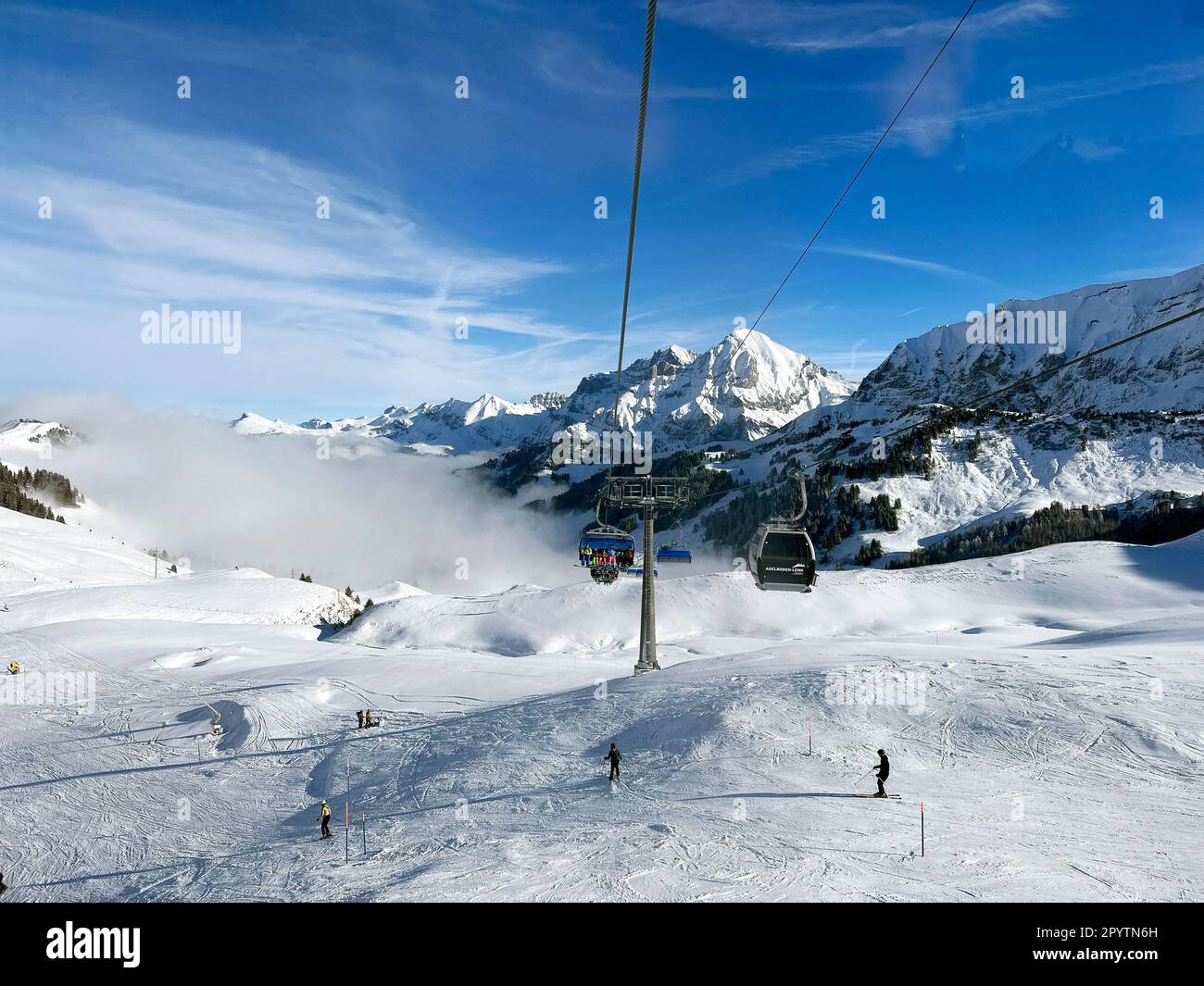 FROM THE SERIES ADELBODEN Cable car in snow in front of wintry ...