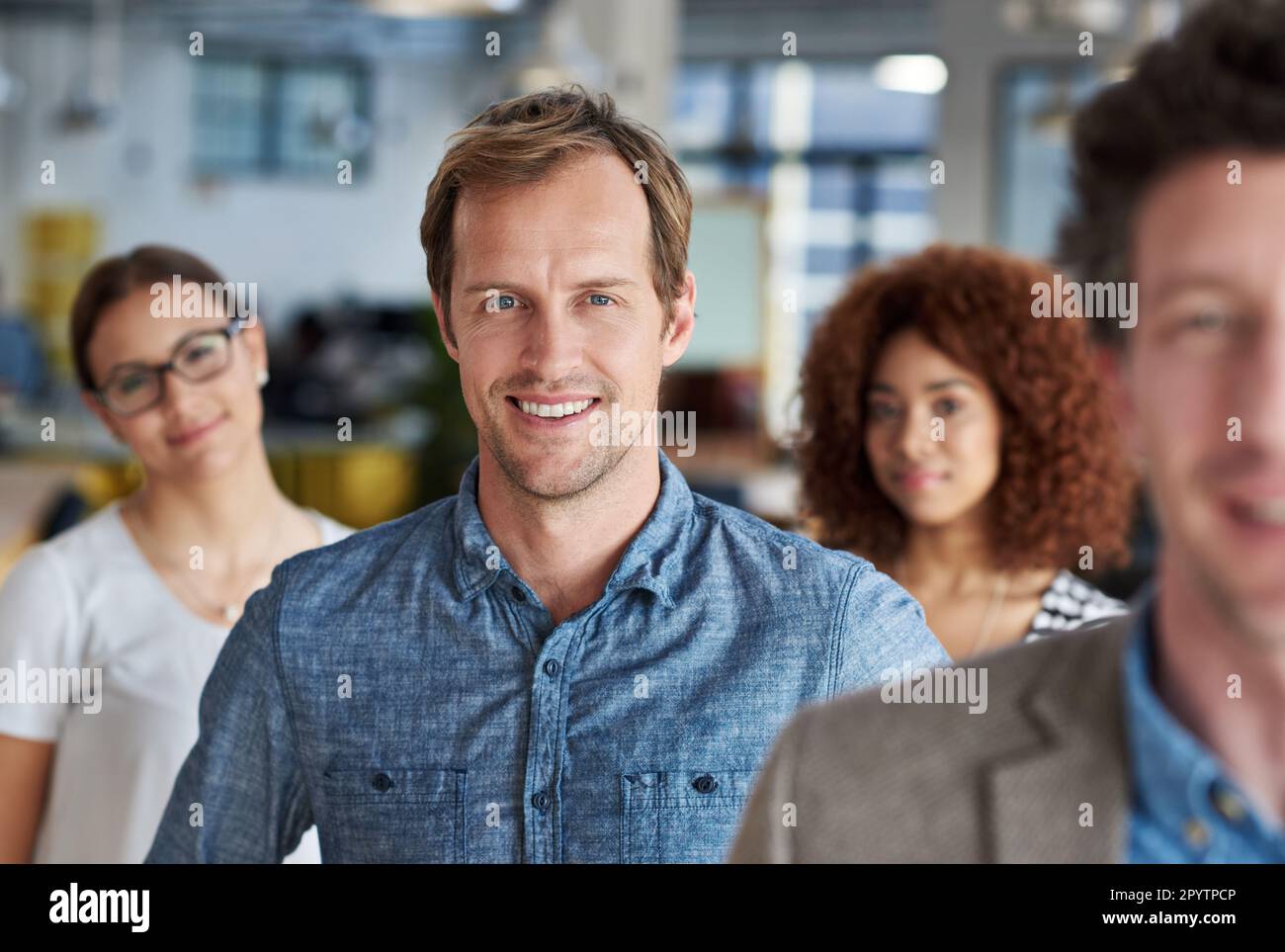 Im proud of my place in the team. Mature man smiling amidst coworkers ...