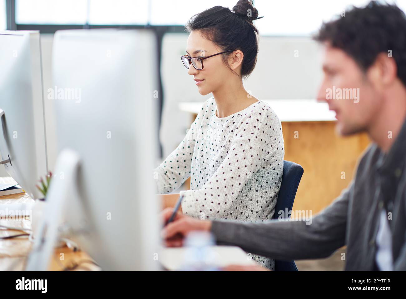 They take design to the next level. two designers sitting at working on ...