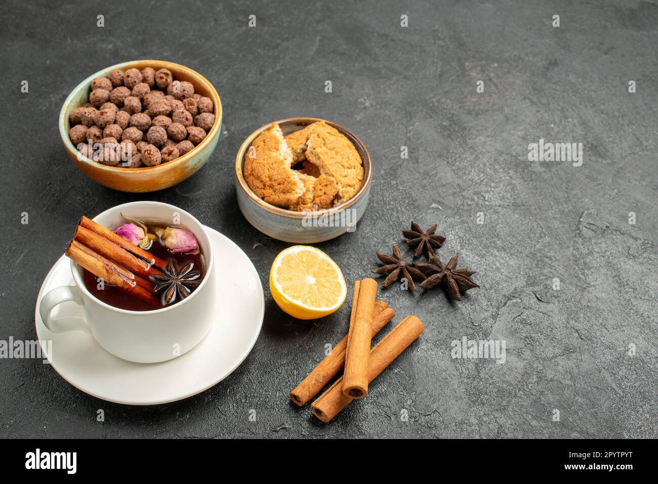 front view cup of tea with cinnamon on the dark grey background tea ...