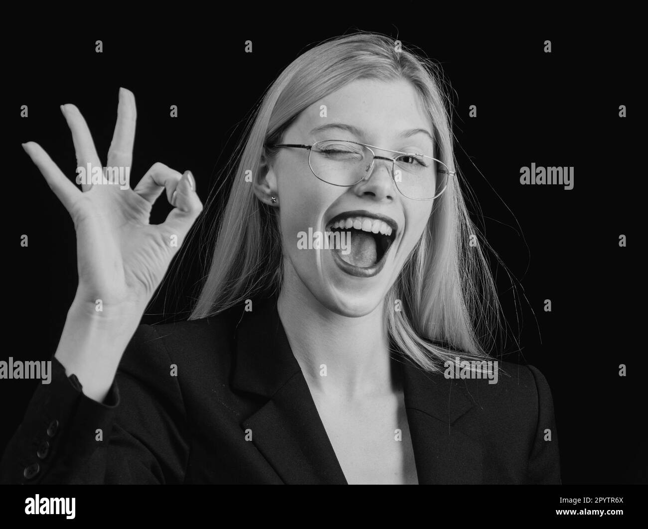 Portrait young shocked business woman winking in front of laptop ...