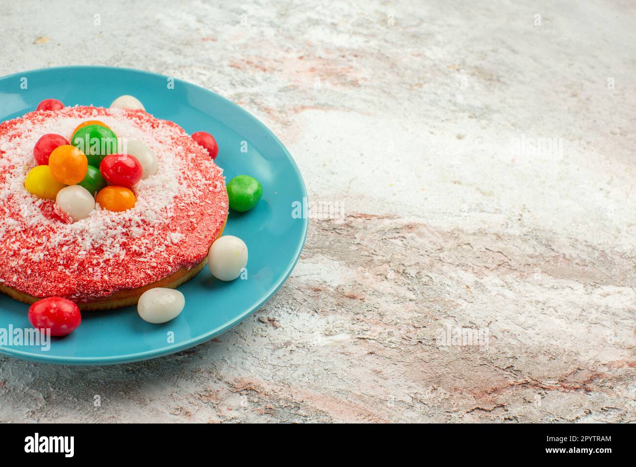 front view delicious pink cake with colorful candies inside plate on a ...