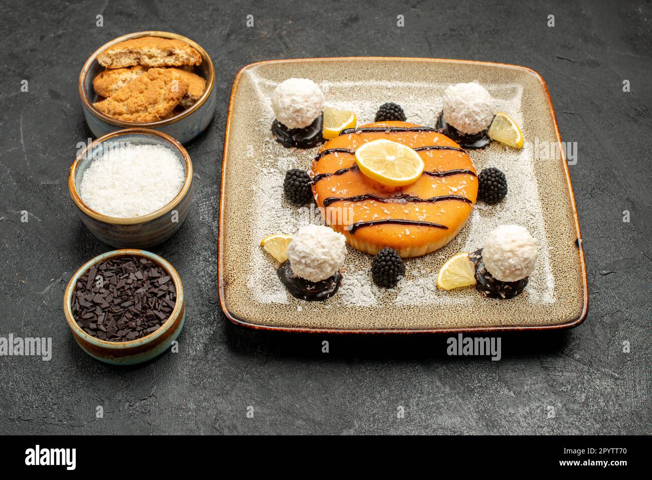 front view sweet yummy pie with coconut candies on dark-grey background ...