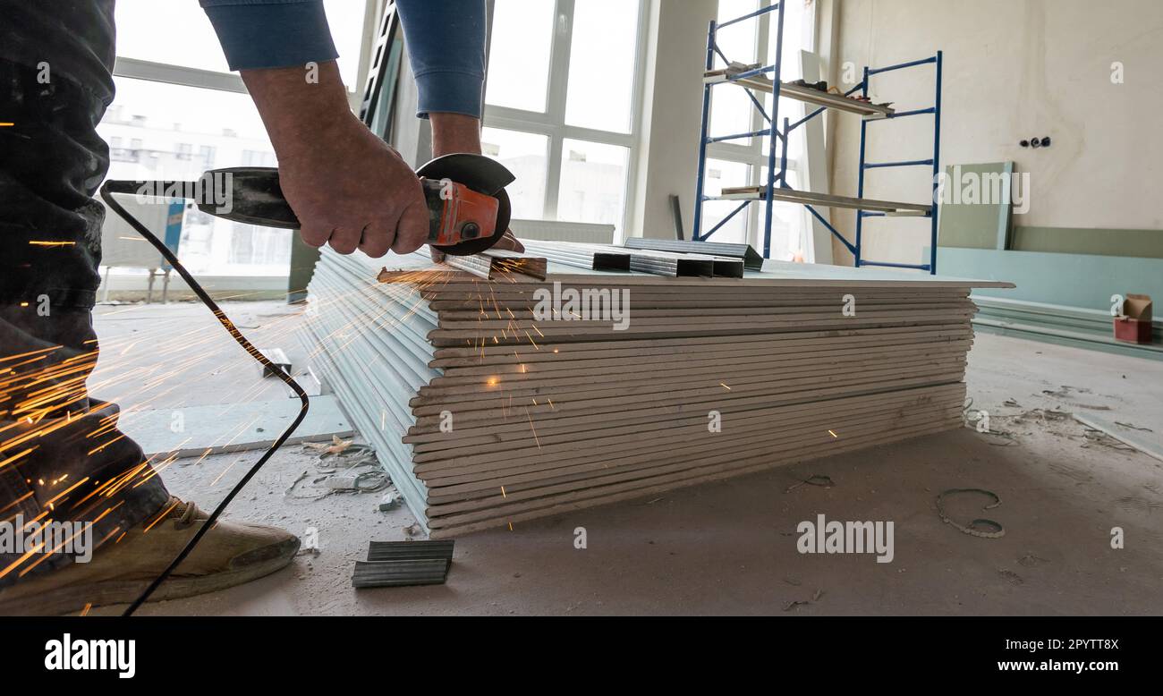 Construction worker, making walls from gypsum plasterboard or drywall ...