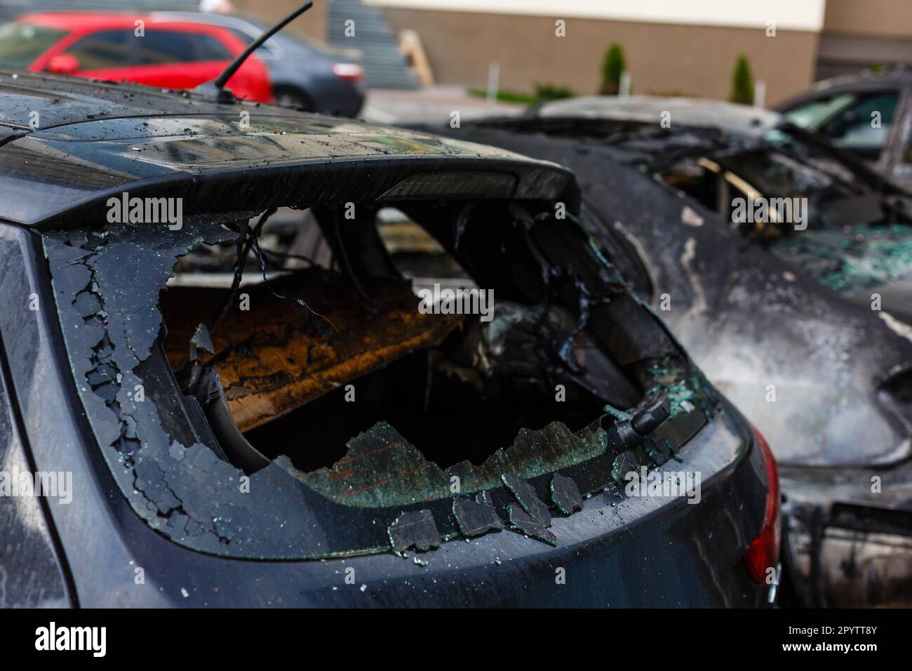 Two cars after the fire. Two burned out cars with an open hood. Arson ...
