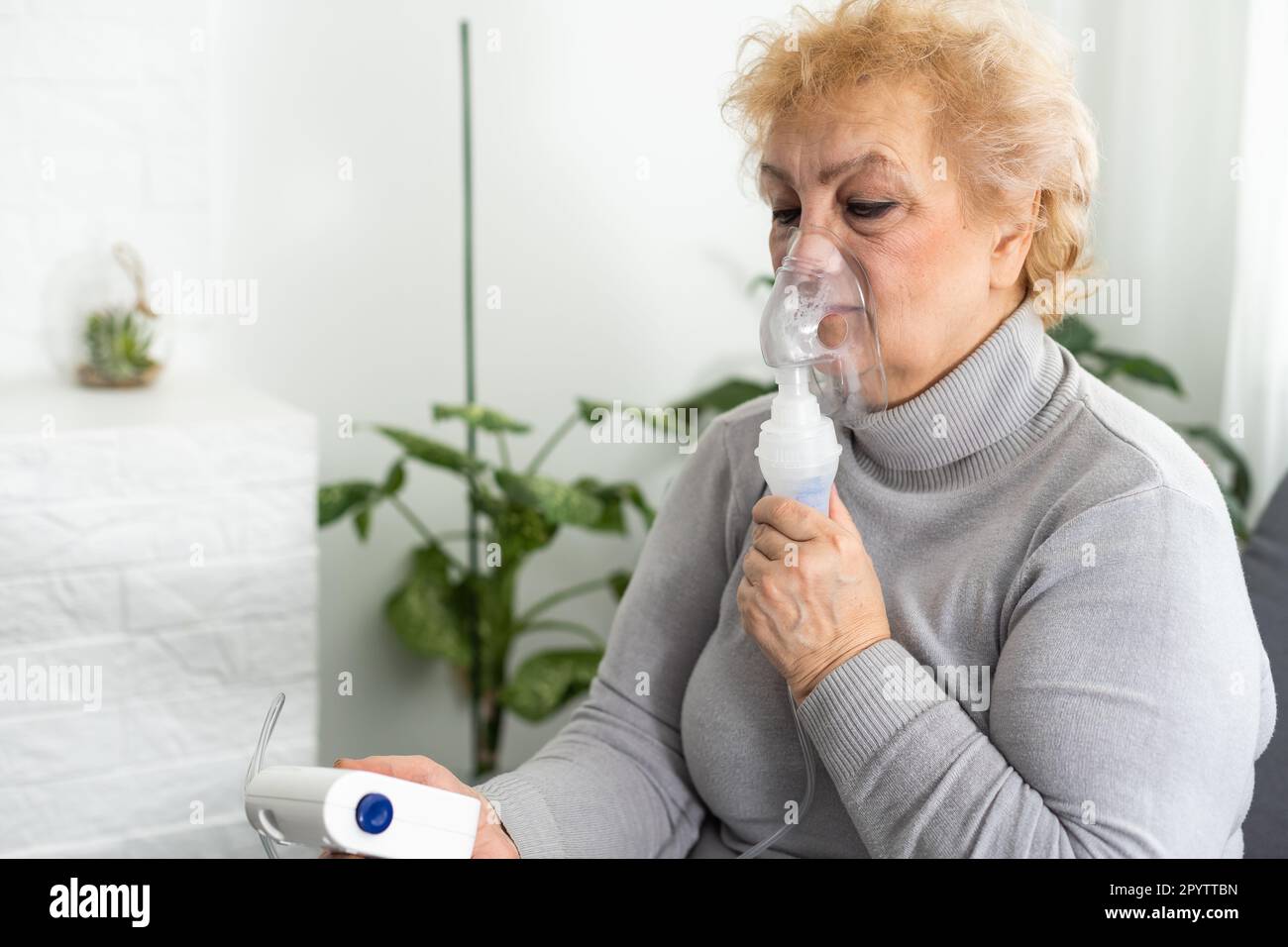 Sick senior woman has a viral infection or flu, labored breathing ...