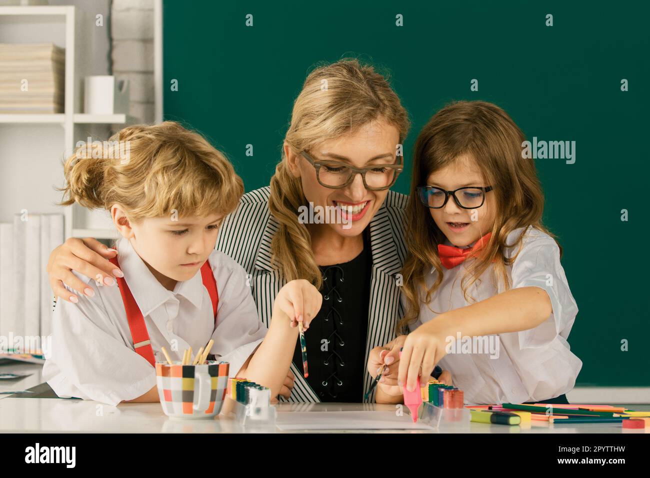 Schoolkids with teacher. Happy children from elementary school study at ...
