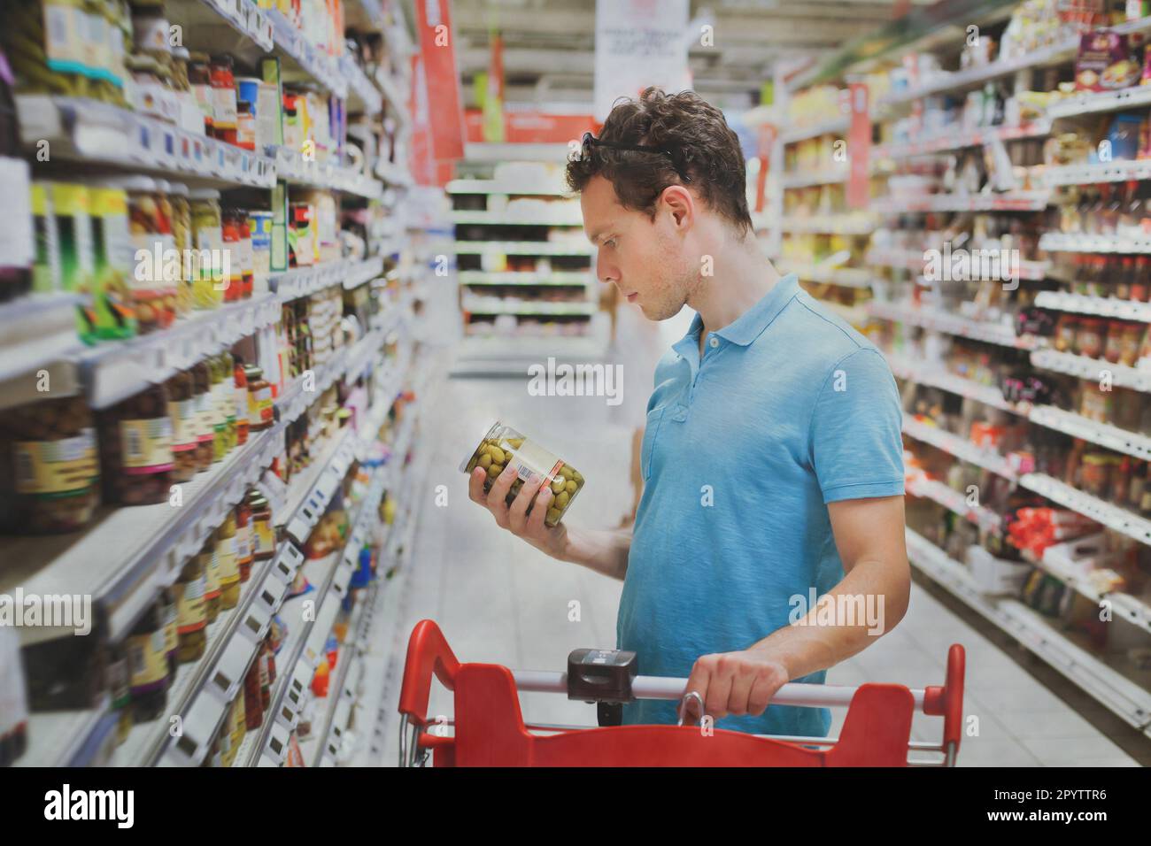 buying food in supermarket grocery store, man customer reading ...