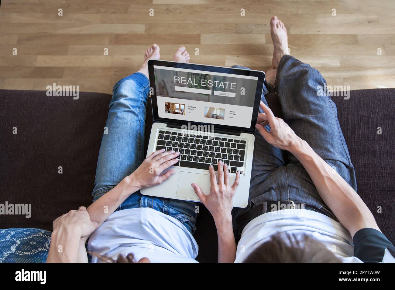 real estate concept on screen of computer, couple looking for apartment ...