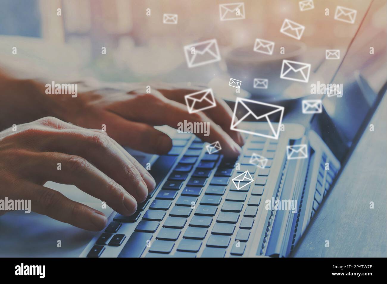 email marketing concept, e-mail icons, hands typing on keyboard as ...