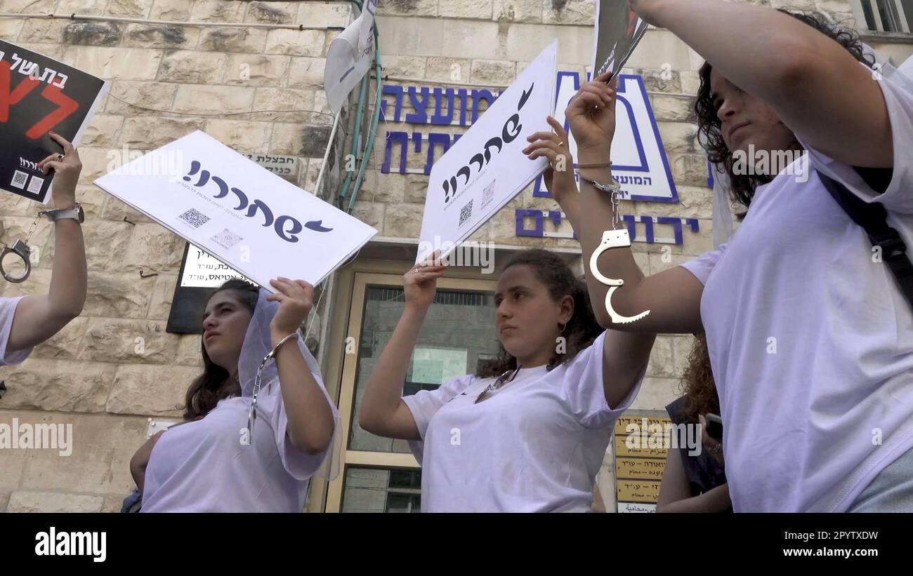 Anti-government protestors hold signs and shackles as they demonstrate ...