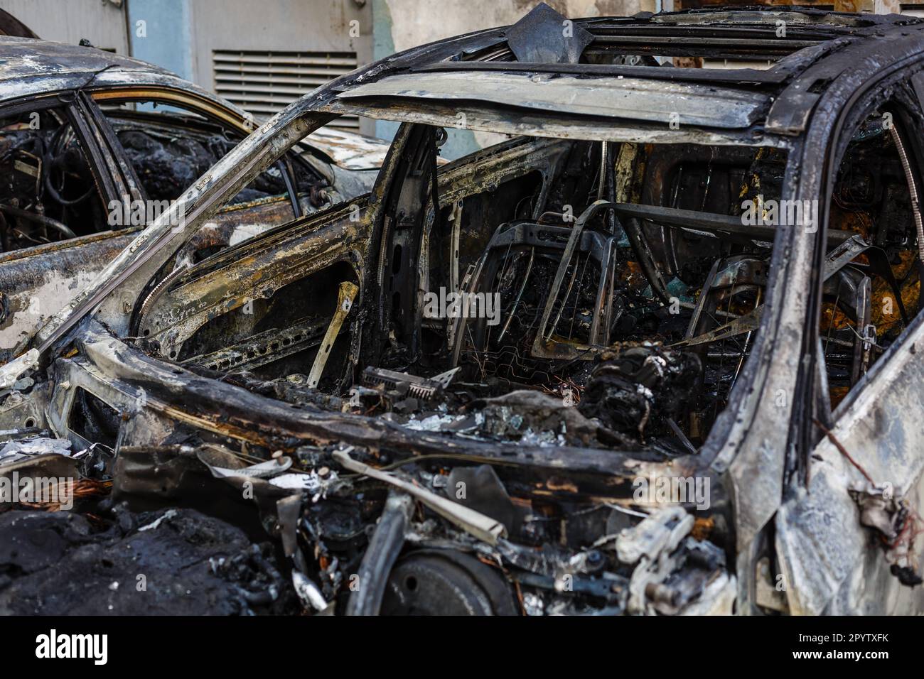 Two cars after the fire. Two burned out cars with an open hood. Arson ...