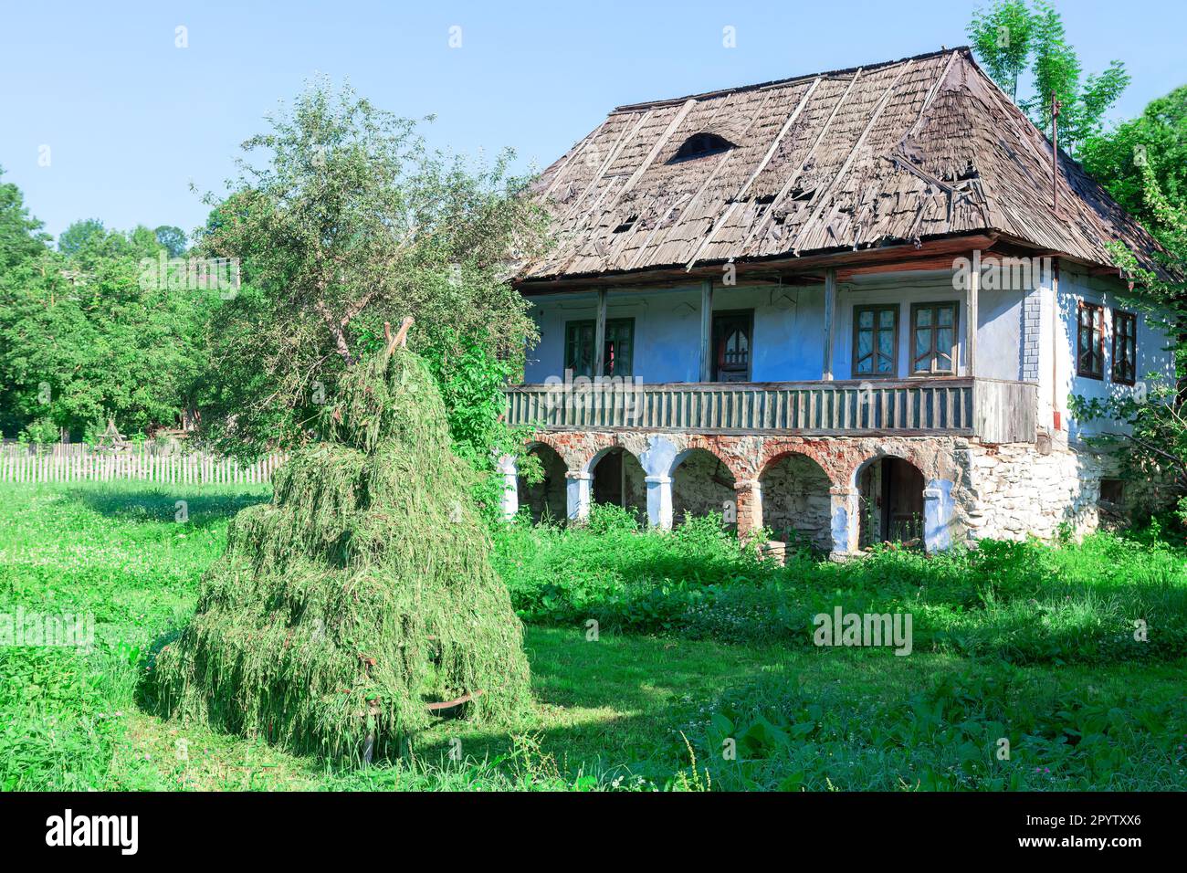 Stack of Grass Near Traditional Rustic House . Old Country House with ...