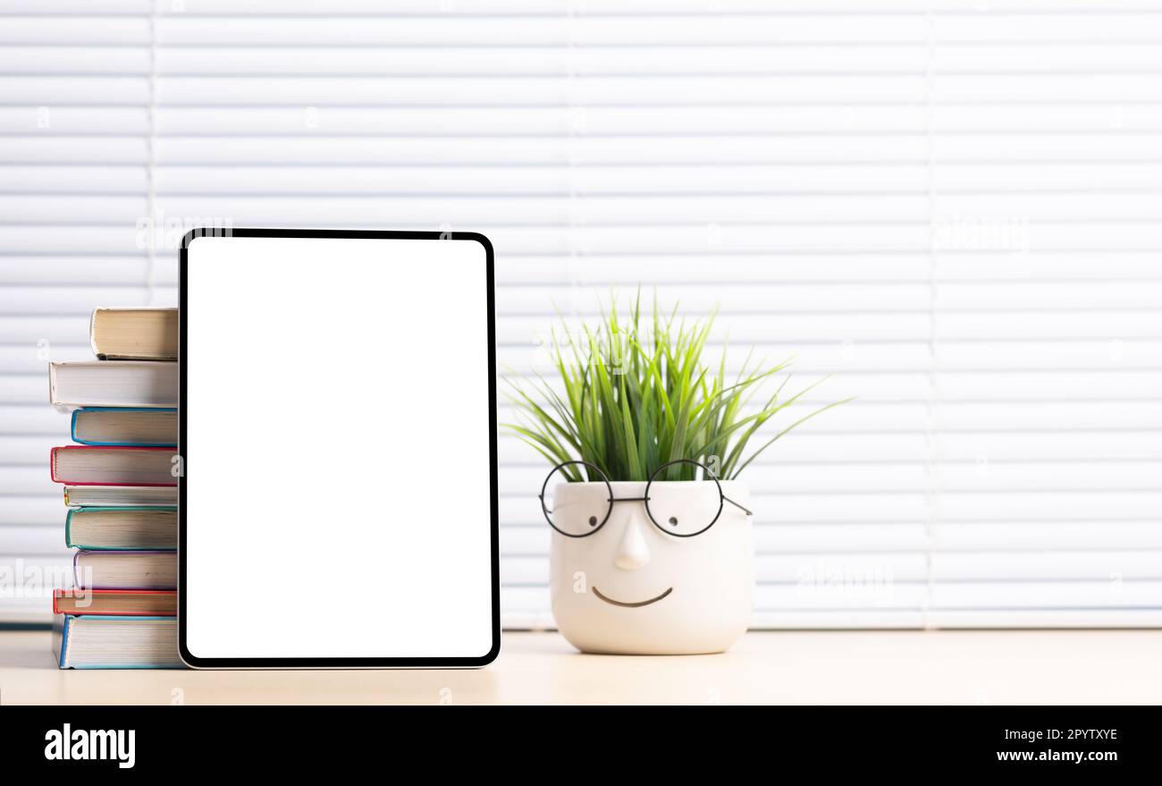 Tablet and stack of books. With blank screen for your text or app Stock ...