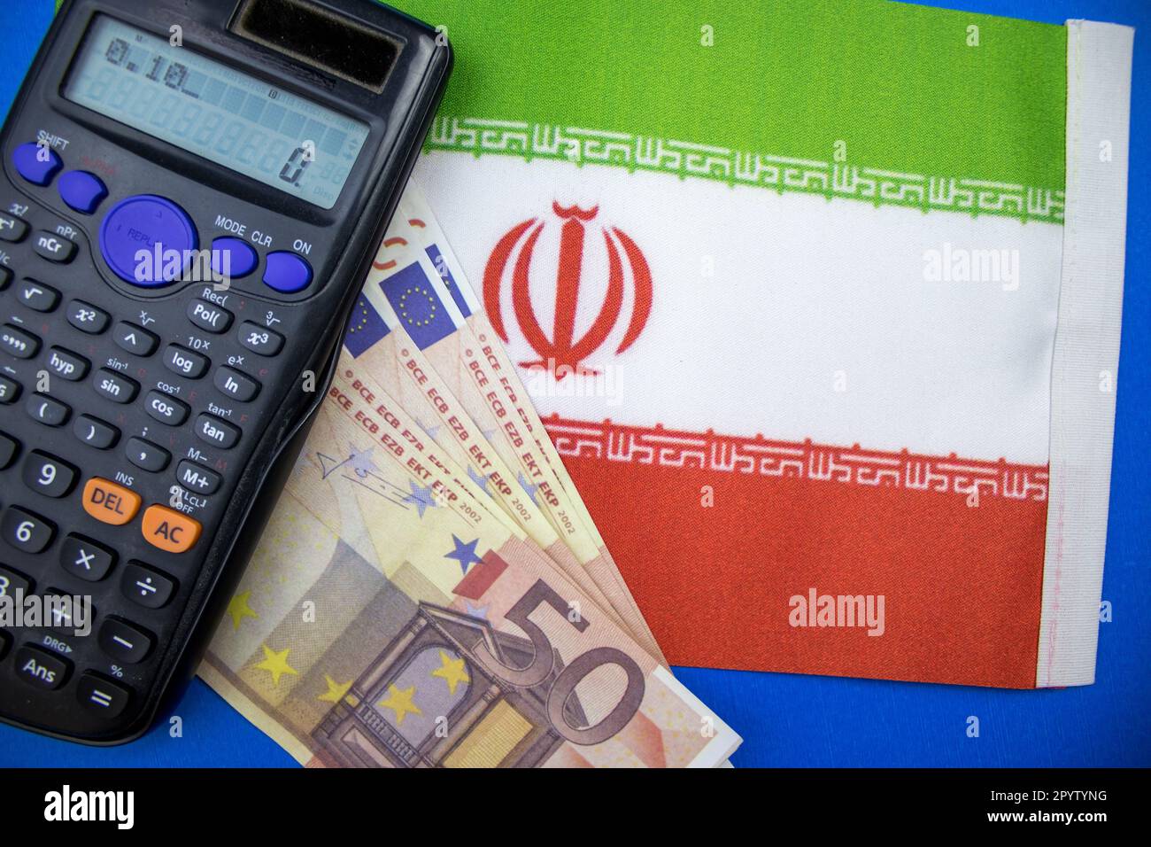 The Iranian flag placed on a blue background, euros and a calculator on ...