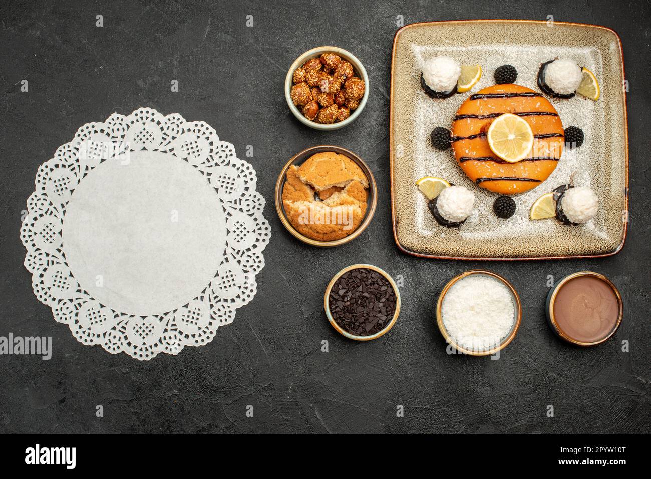 top view delicious cake dessert with coconut candies on dark grey ...