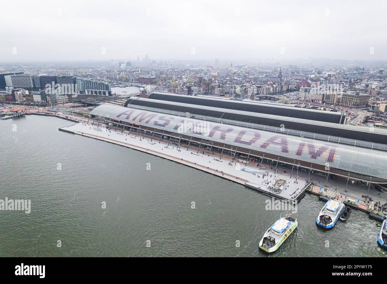 Amsterdam cityscape top view on a cloudy day. River with ships, boats ...