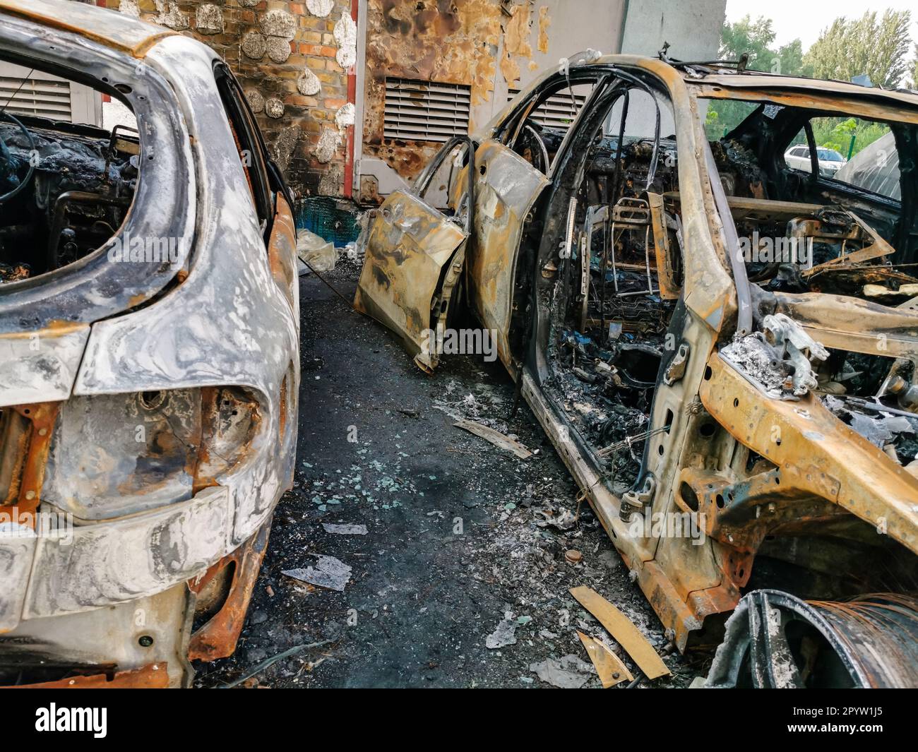 Two cars after the fire. Two burned out cars with an open hood. Arson ...