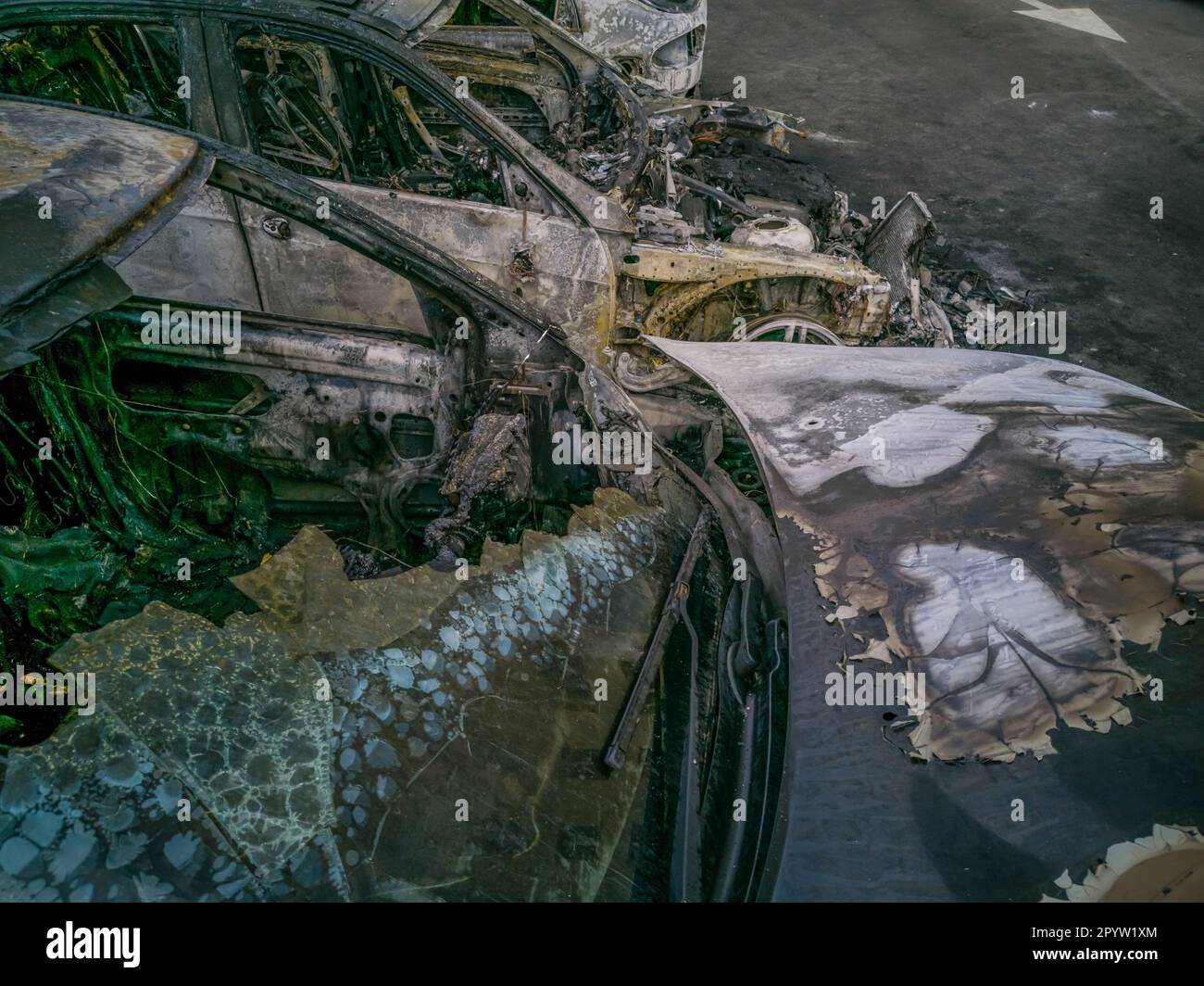 Two cars after the fire. Two burned out cars with an open hood. Arson ...