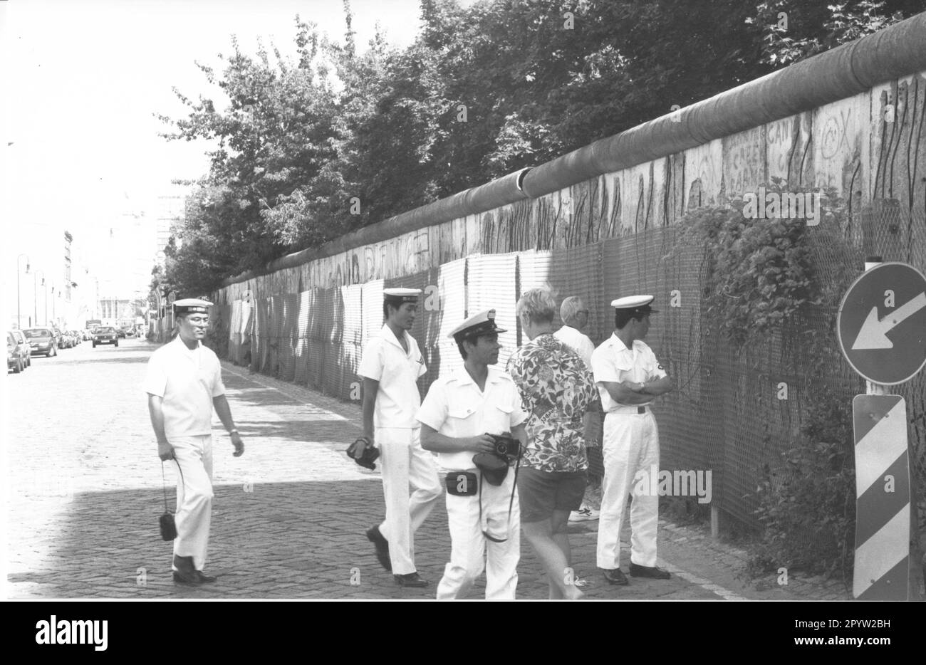 Berlin Wall in Niederkirnerstraße. Japanese military visits the Wall ...