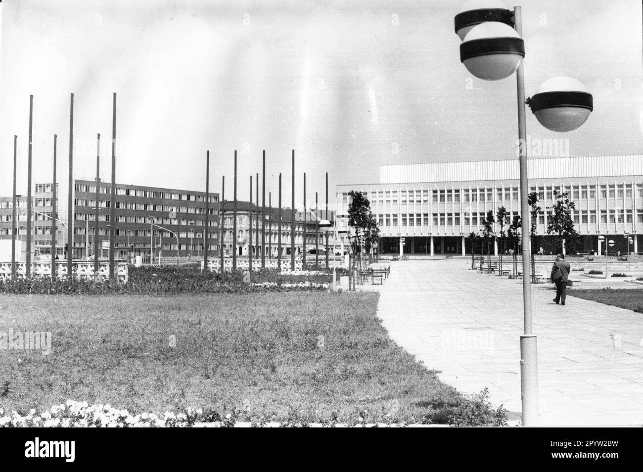The old redesigned market with a view of the square, flagpoles and ...