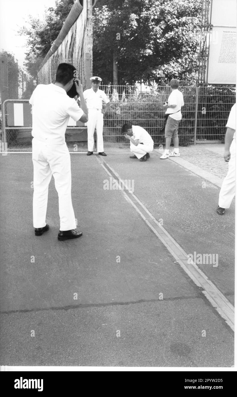 Berlin Wall in Niederkirnerstraße. Japanese military visits the Wall ...