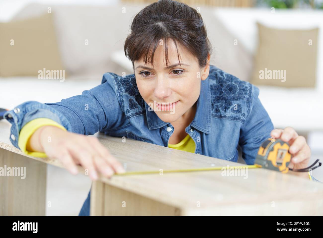 cute hispanic woman doing some woodwork Stock Photo - Alamy