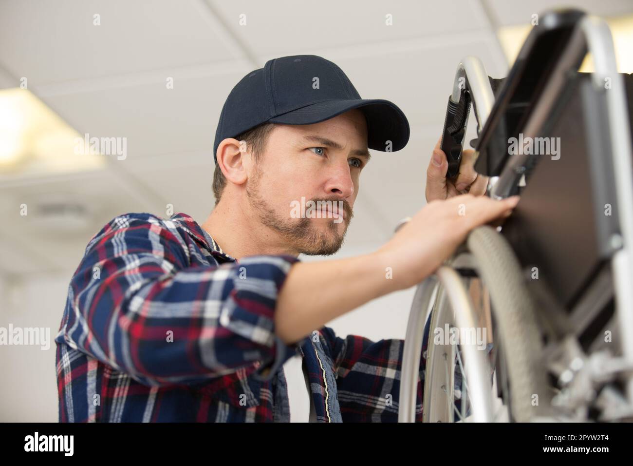 worker is fixing a wheelchair Stock Photo - Alamy
