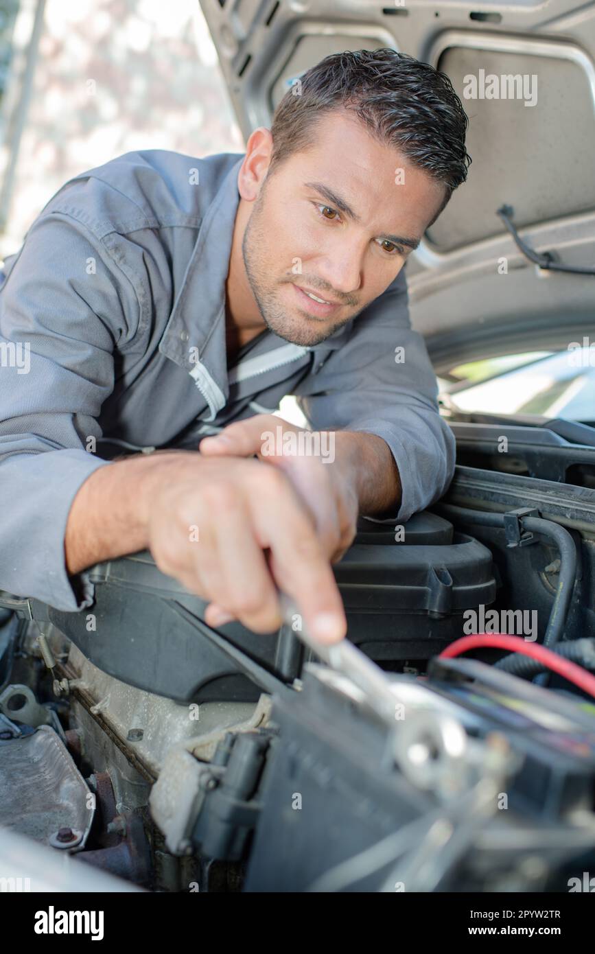a man fixing an engine Stock Photo - Alamy