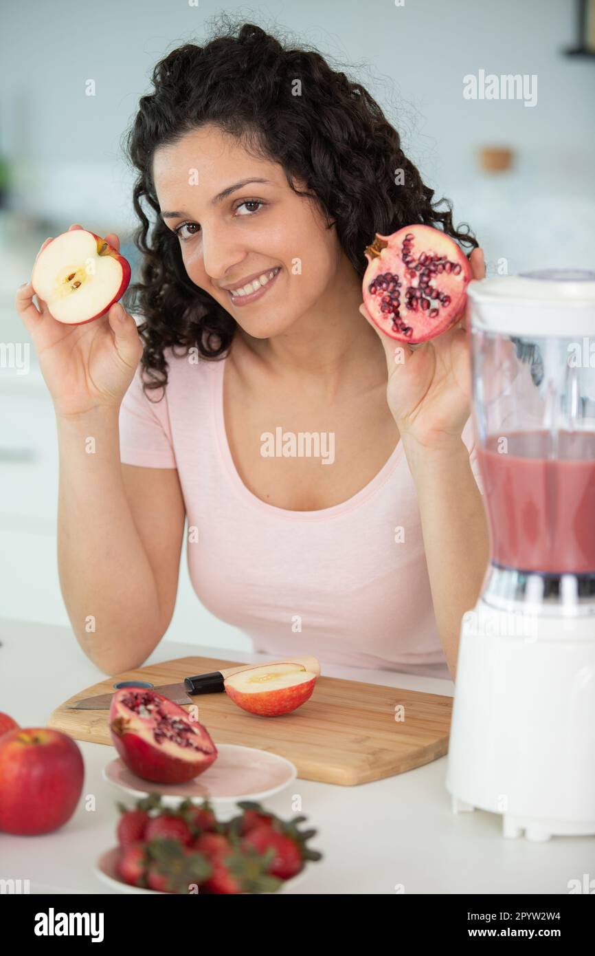 beautiful woman making fruits smoothies with blender Stock Photo - Alamy