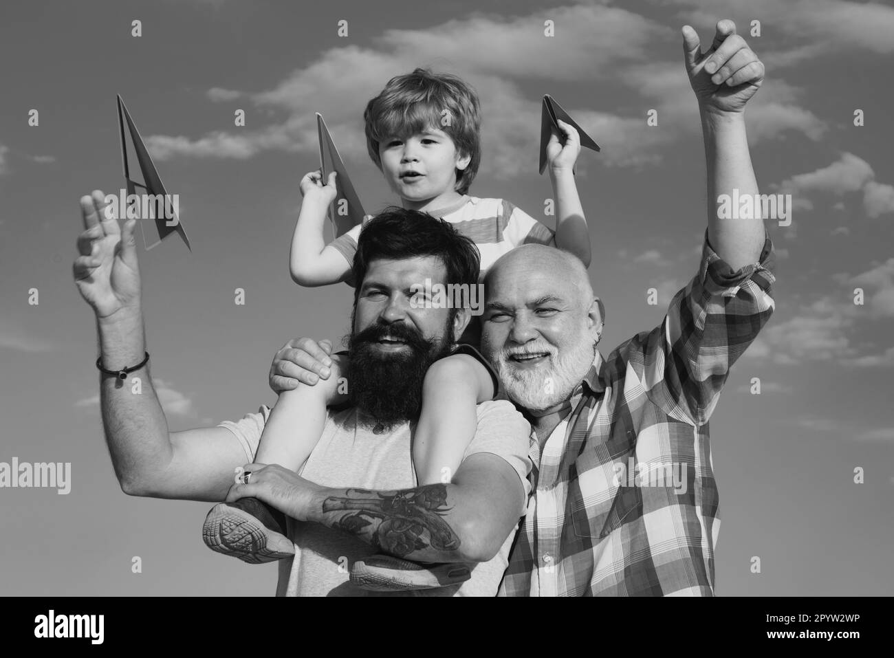 Men generation: grandfather father and grandson are hugging looking at ...