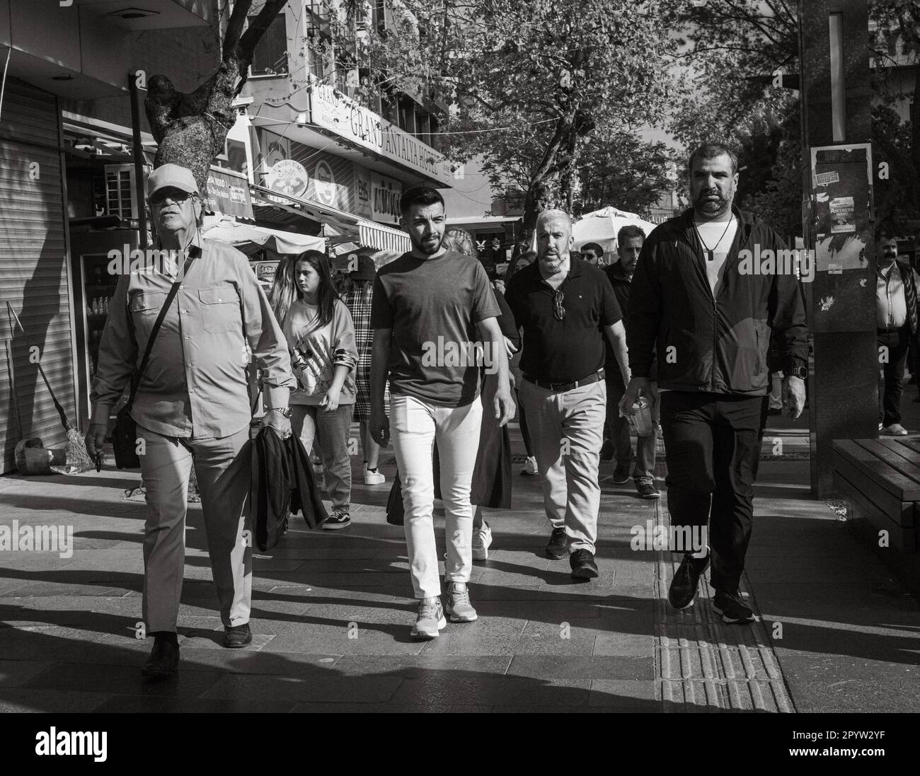 Turkish men of different ages walk down a bustling shopping street in ...