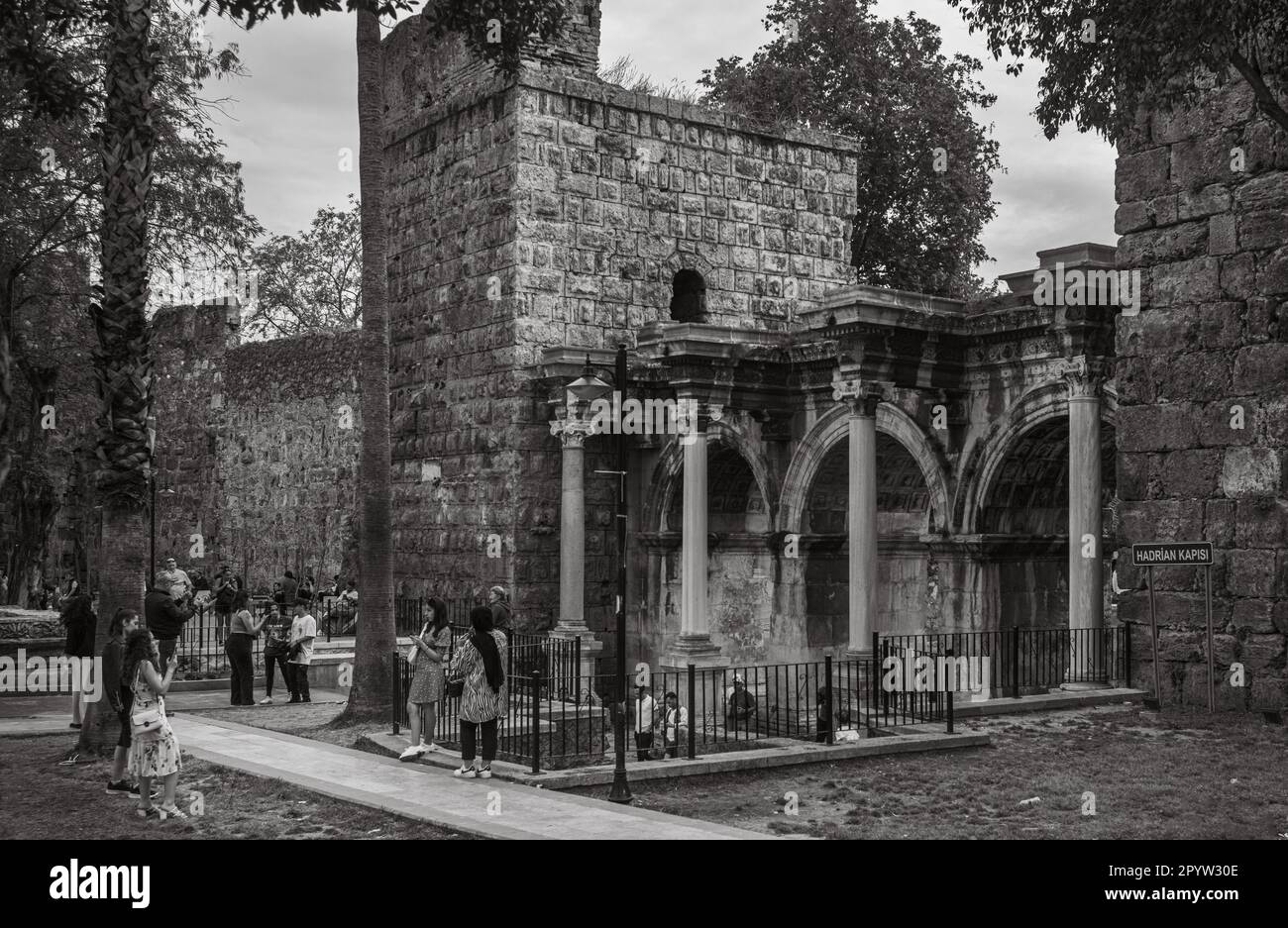 Tourists visit the beautifully well-preserved Roman-era Hadrian's Gate in Kaleici, Antalya ...