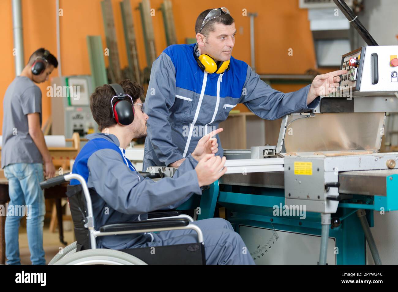 worker in wheelchair in a factory Stock Photo - Alamy