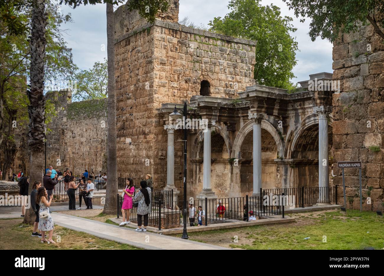 Tourists visit the beautifully well-preserved Roman-era Hadrian's Gate ...