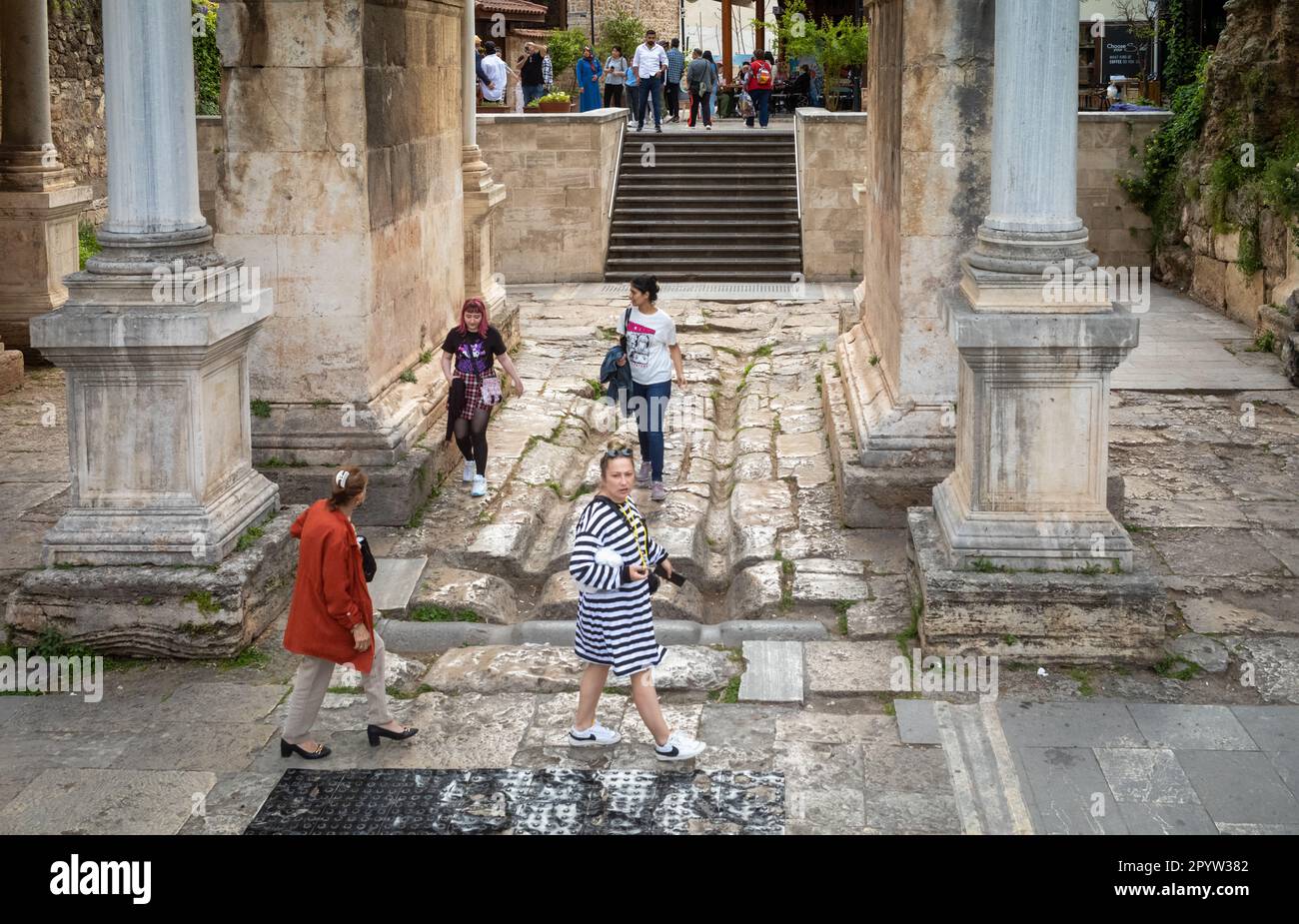 Tourists visit the beautifully well-preserved Roman-era Hadrian's Gate in Kaleici, Antalya ...