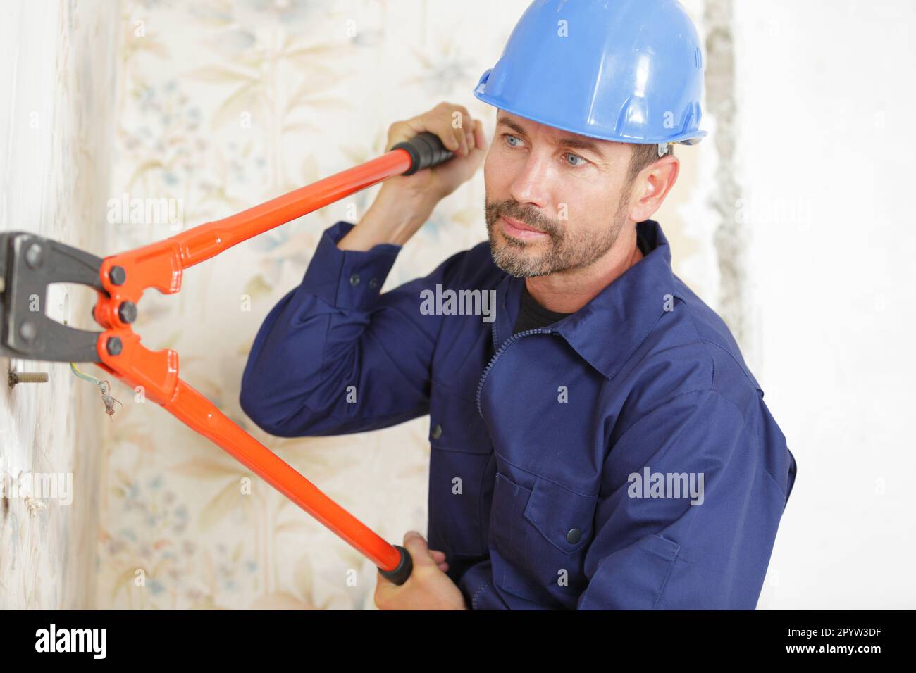 workman working with mower indoors Stock Photo - Alamy
