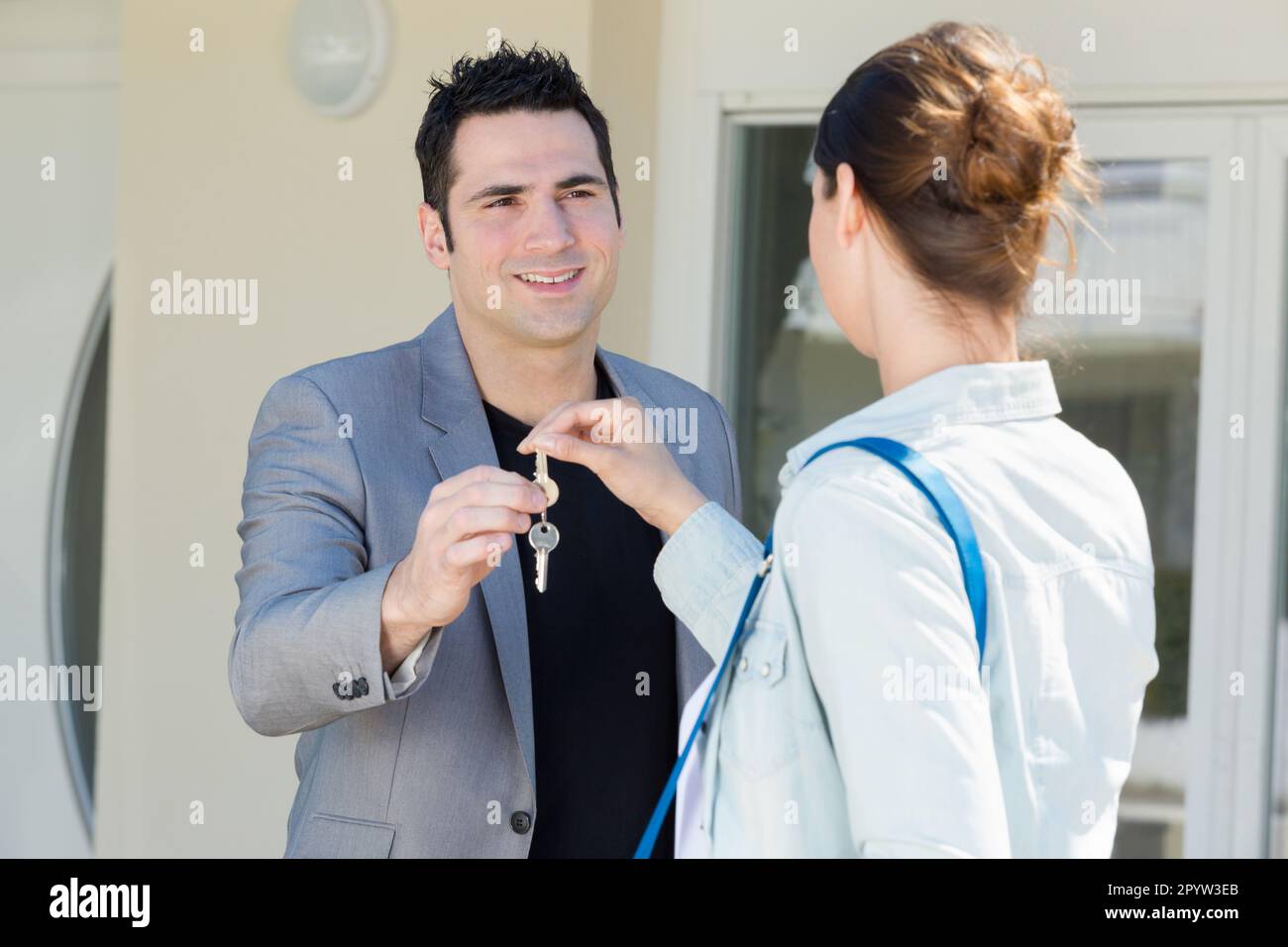 Man passing woman house keys hi-res stock photography and images - Alamy