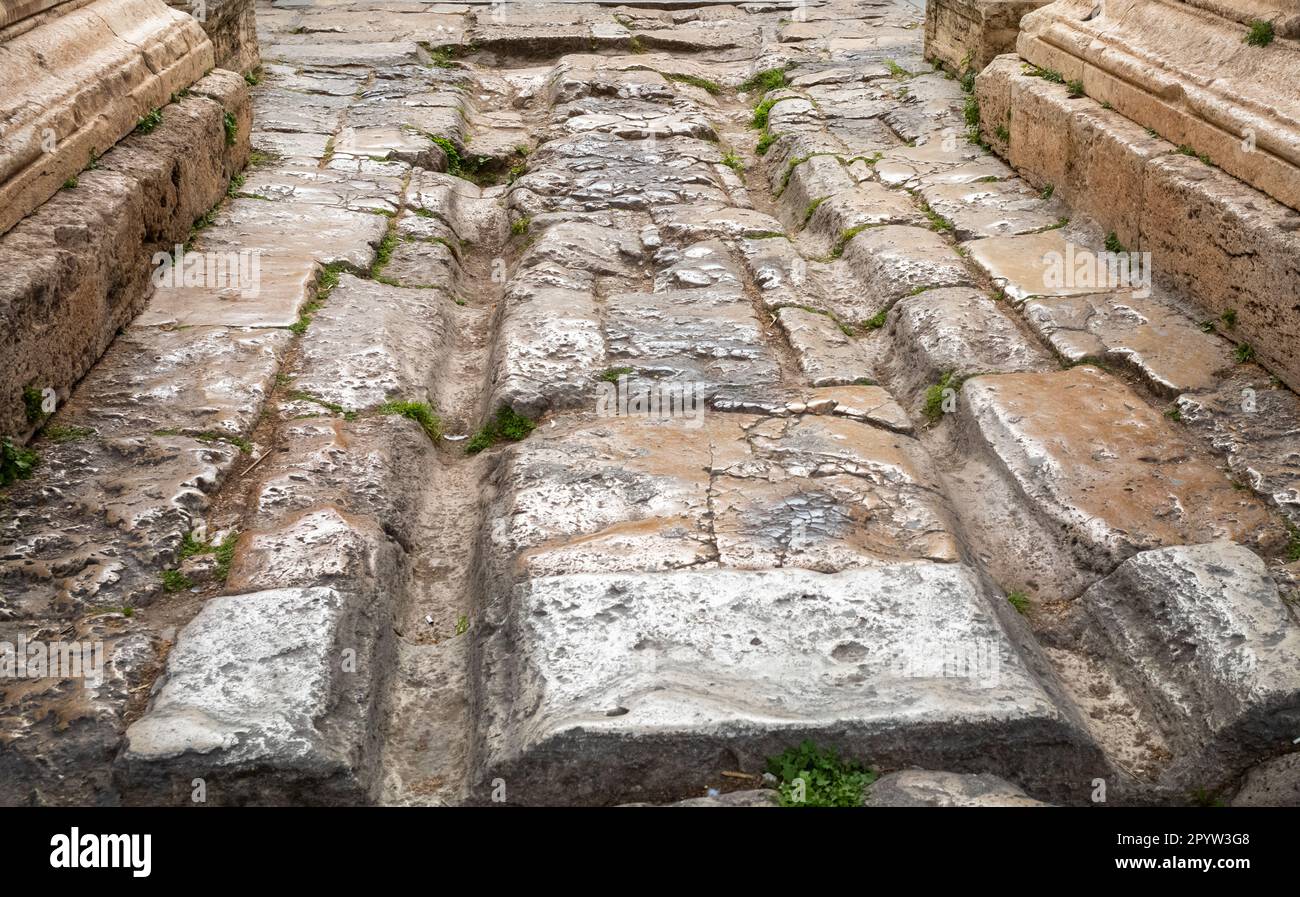 The deeply rutted pavement of the Roman-era roadway that passes through ...