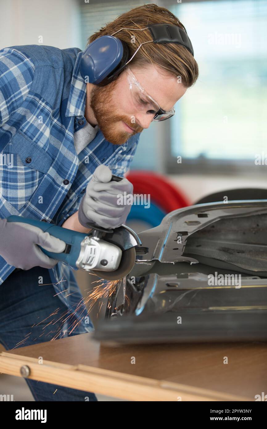 man using an angle grinder Stock Photo - Alamy
