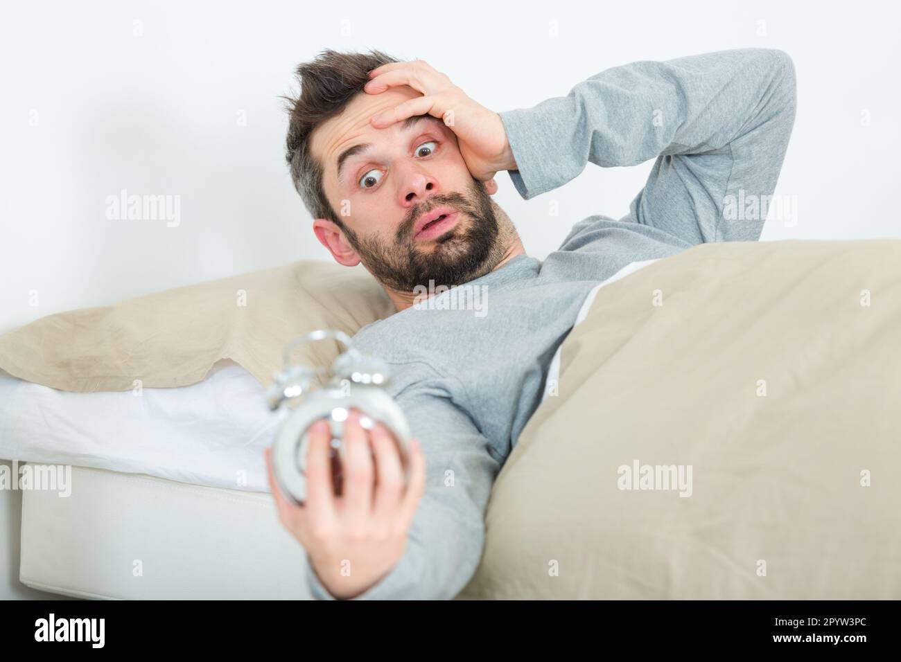 Shocked young man alarm hi-res stock photography and images - Alamy