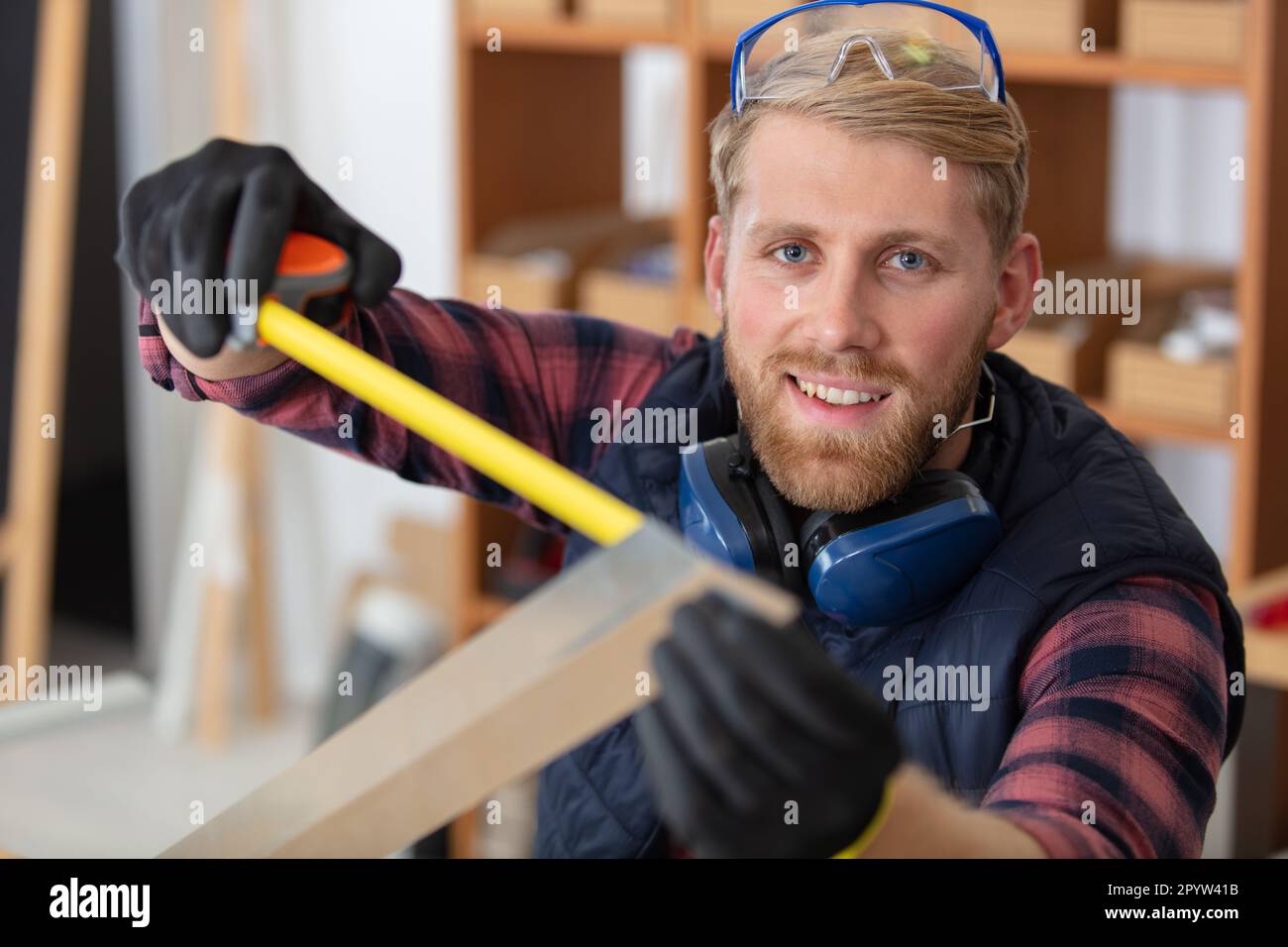 construction worker using measuring tape Stock Photo - Alamy