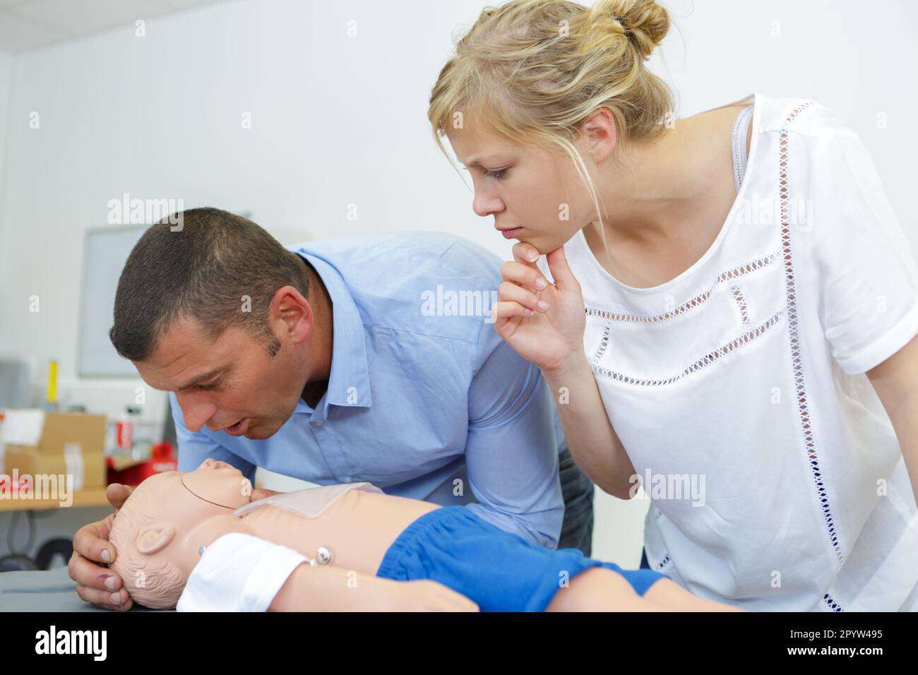 cpr practice of woman and man on cpr baby dummy Stock Photo - Alamy