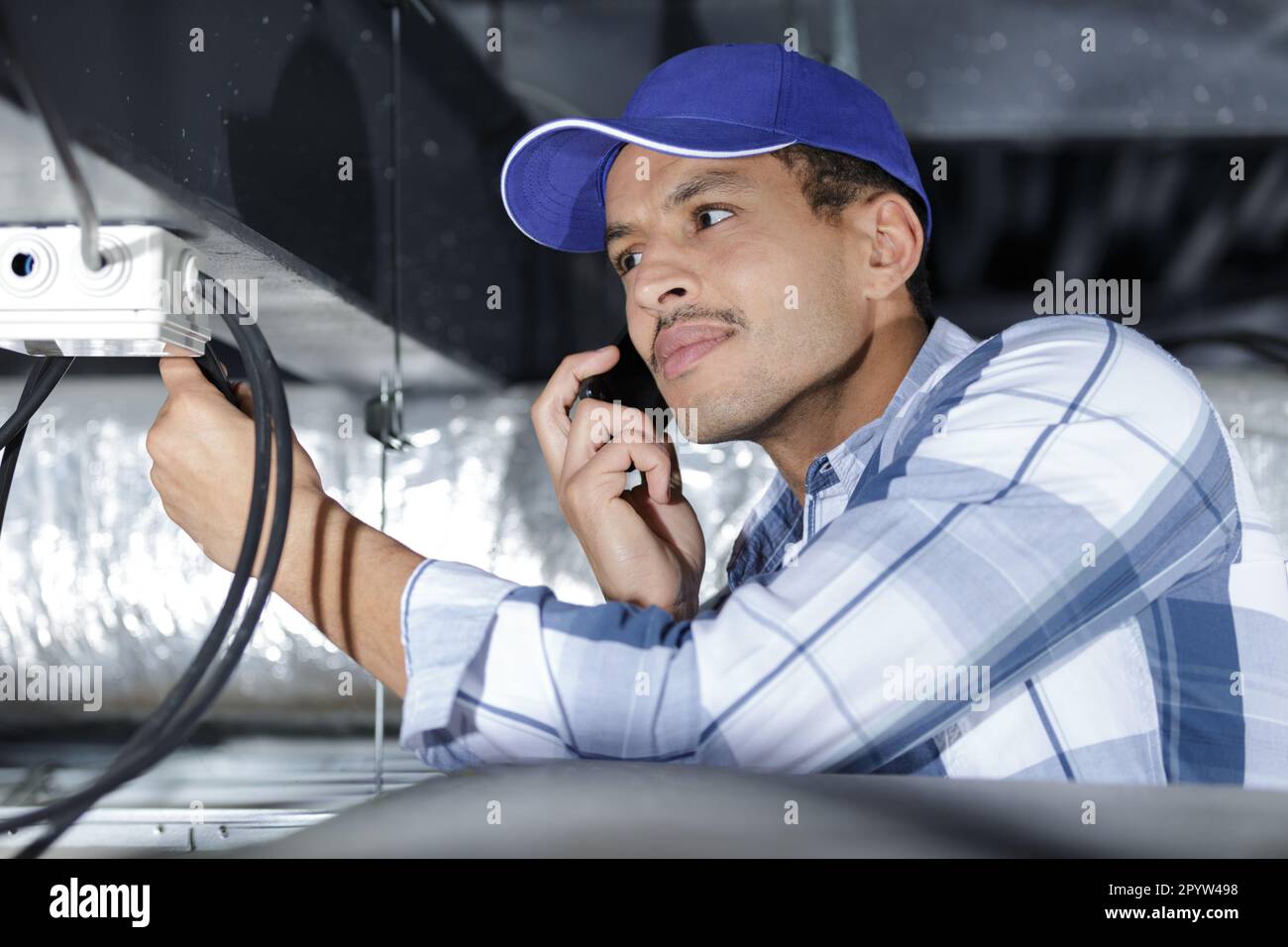 electrician contractor on the phone with cables Stock Photo - Alamy