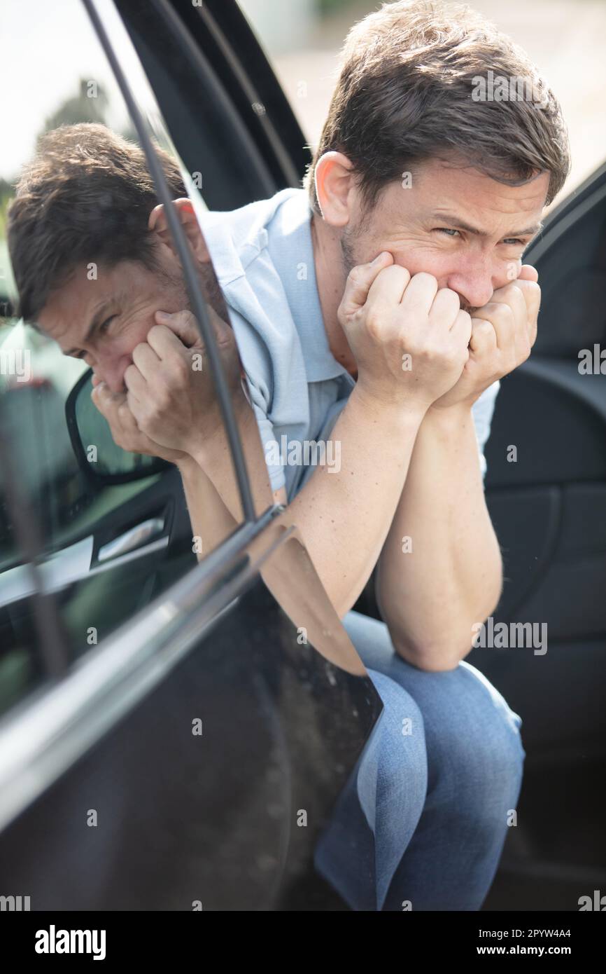 portrait of stressed man sitting on car drivers seat Stock Photo - Alamy