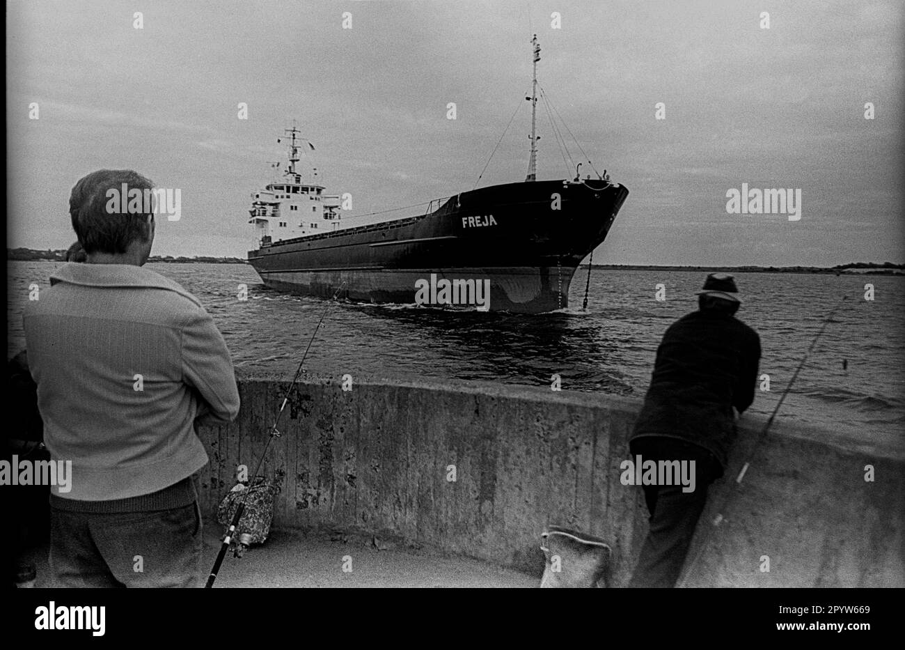 Cargo ship and angler Black and White Stock Photos & Images - Alamy